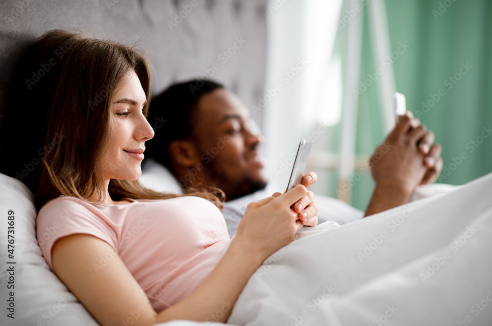 Gadget addiction concept. Young multiethnic family using smartphones ...