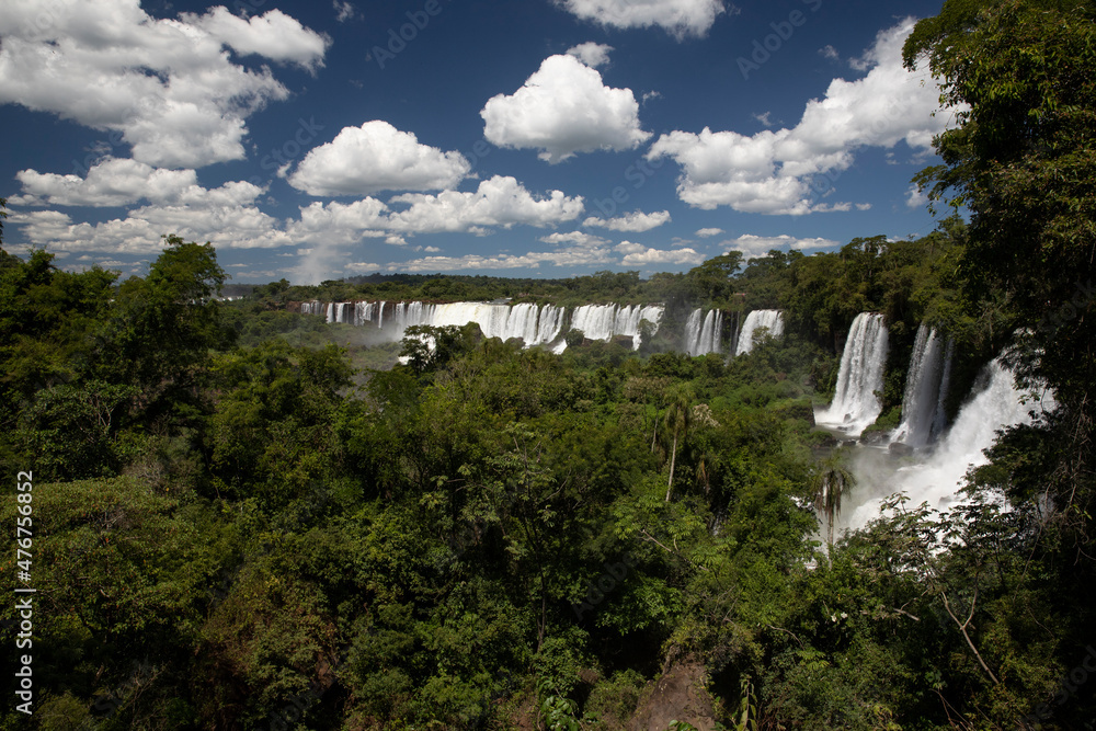 The Iguazu falls in the jungle. View of the white falling water flowing ...