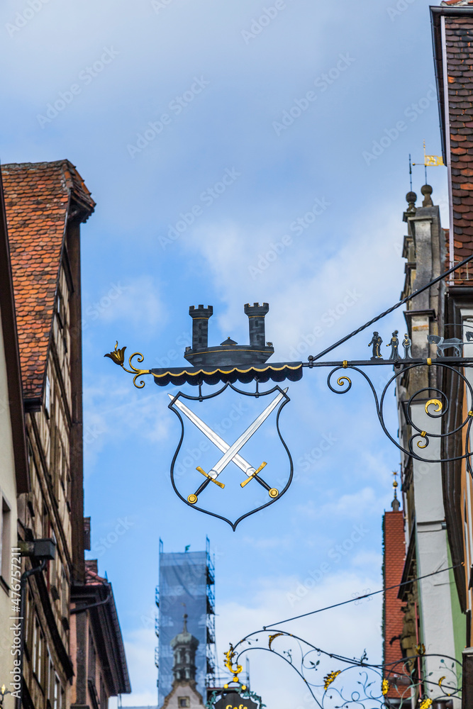 Medieval shop signage with sword and castle symbolizing an armourer ...