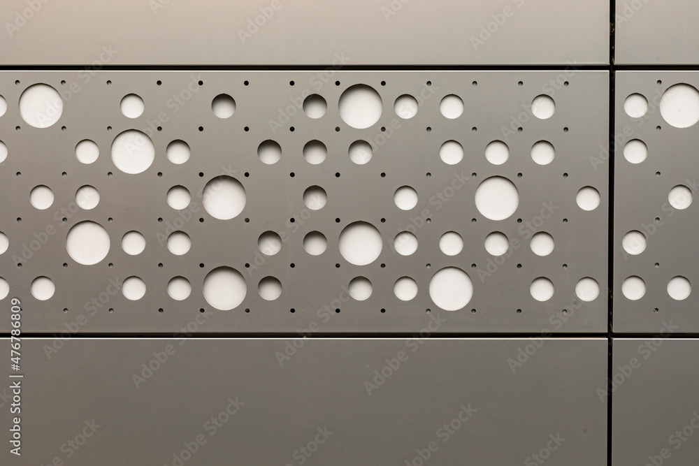 Round hole tiles. Metal cladding of the building facade Stock Photo ...