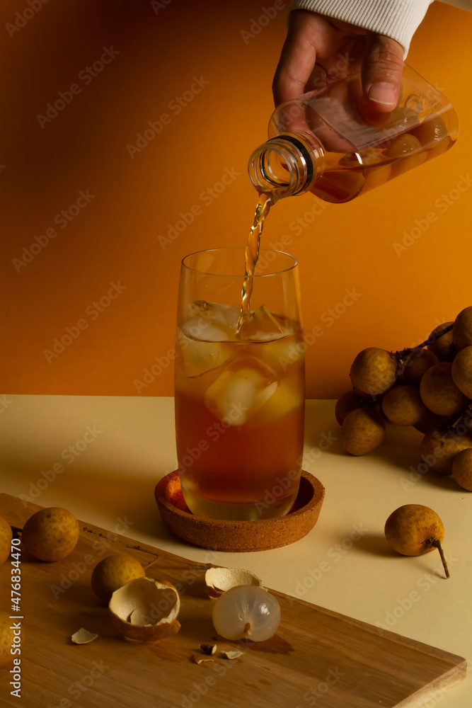 Pour longan drink with fresh fruit peel the skin show white meat and ...