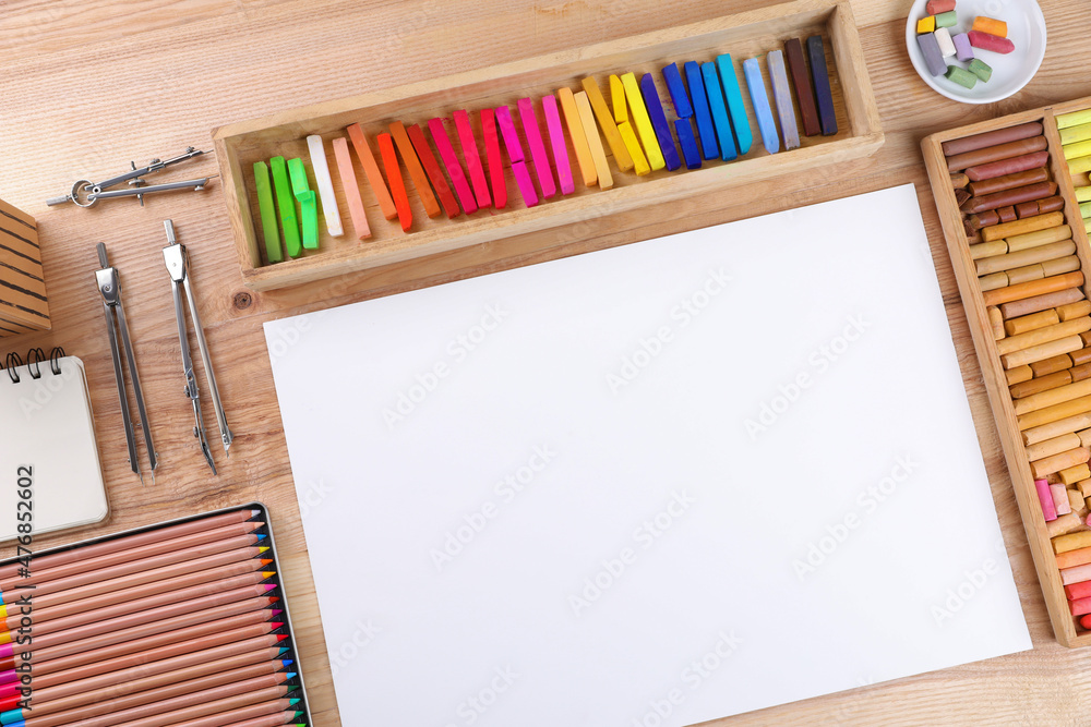 Layout with blank paper, soft pastels and other drawing supplies on ...
