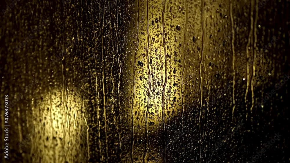 Close-up of water droplets on glass, Rain Rain, Go Away. Large rain drops strike a window pane ...