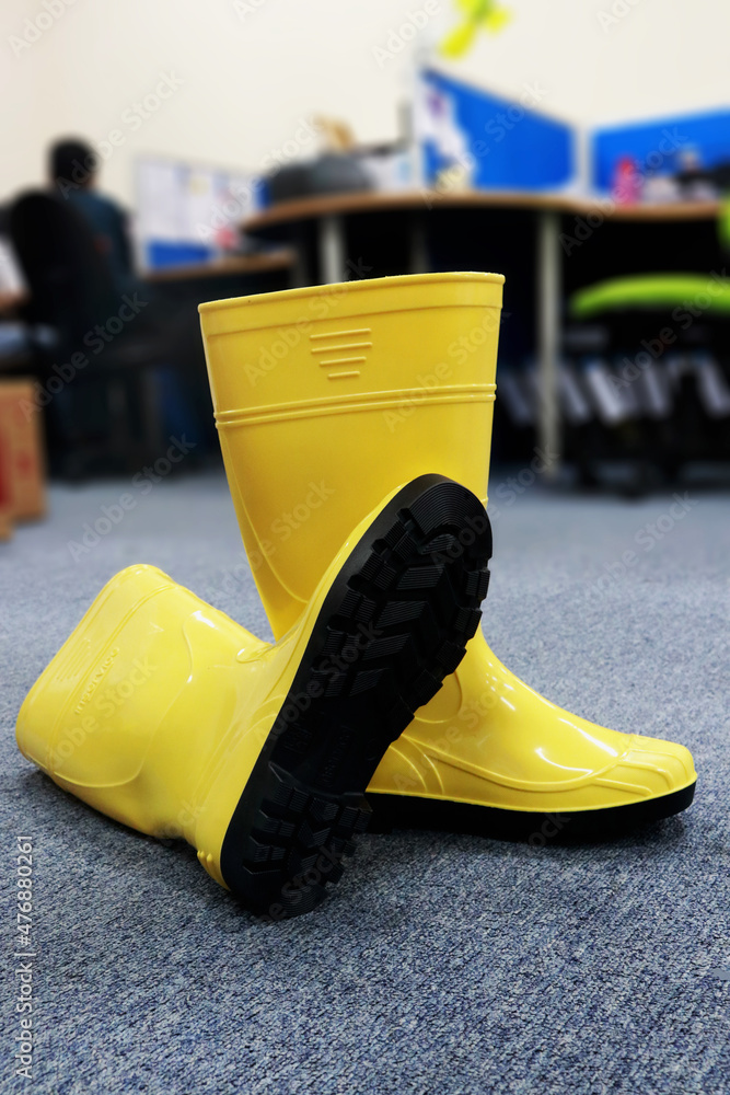 Yellow rubber boots that are waterproof are usually worn by ...