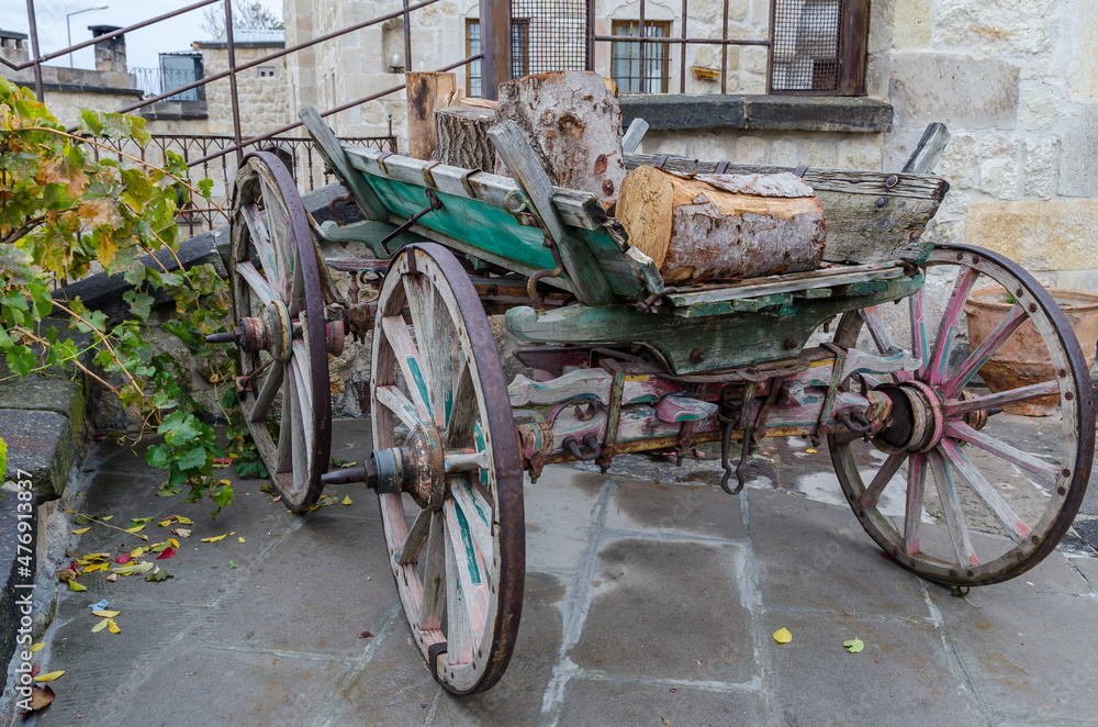 Old broken wooden wagon with green sides, wheels with metal rims and ...