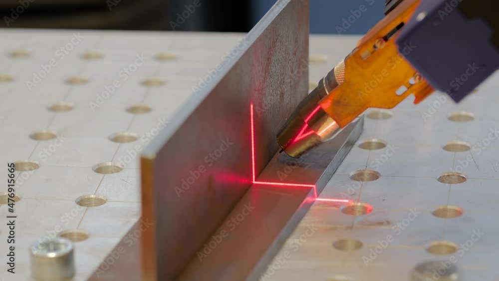 Industrial robotic arm of welding robot scanning metal workpiece with ...