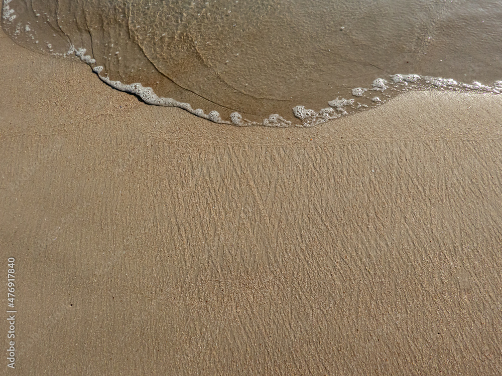 Lines in the sand of natural waves forming lozenge patterns when ocean ...