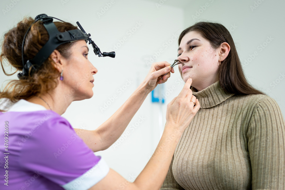 Otolaryngology concept. Positive woman otorhinolaryngologist checking ...