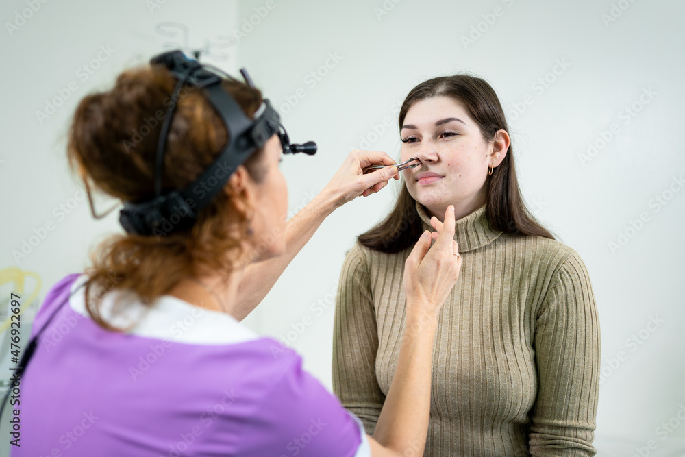 Otolaryngology concept. Positive woman otorhinolaryngologist checking ...