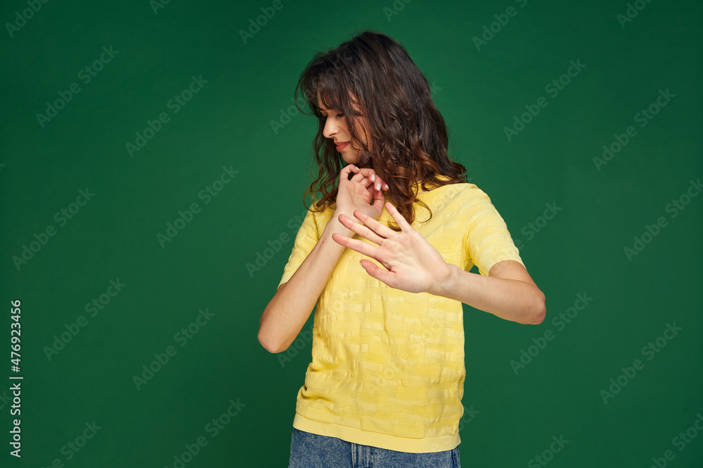 Displeased young girl doing stop gesture turn away from something ...