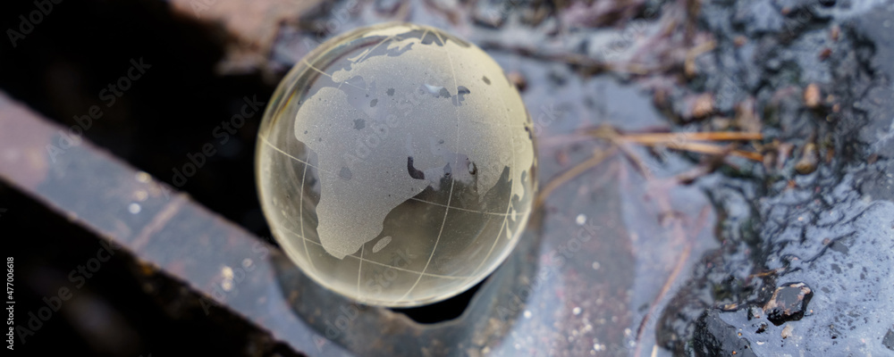 Glass ball - a planet lying on the grate of a drainage pit to collect ...