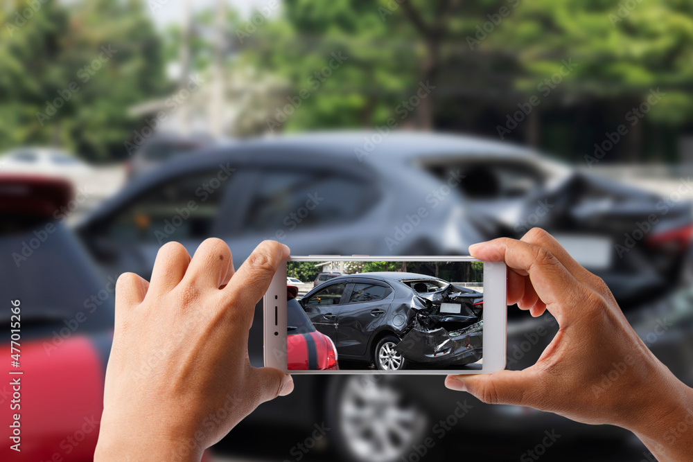 Close-up hand holding smartphone and take photo of car accident for ...