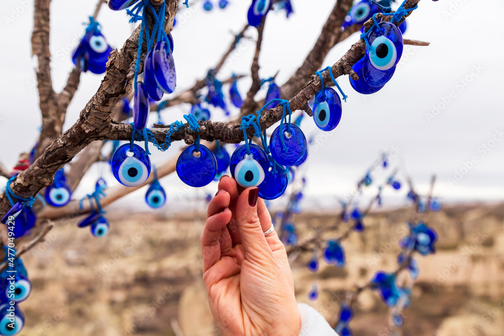 Blue evil eye, nazar boncugu, Turkish symbols hanging on a tree ...