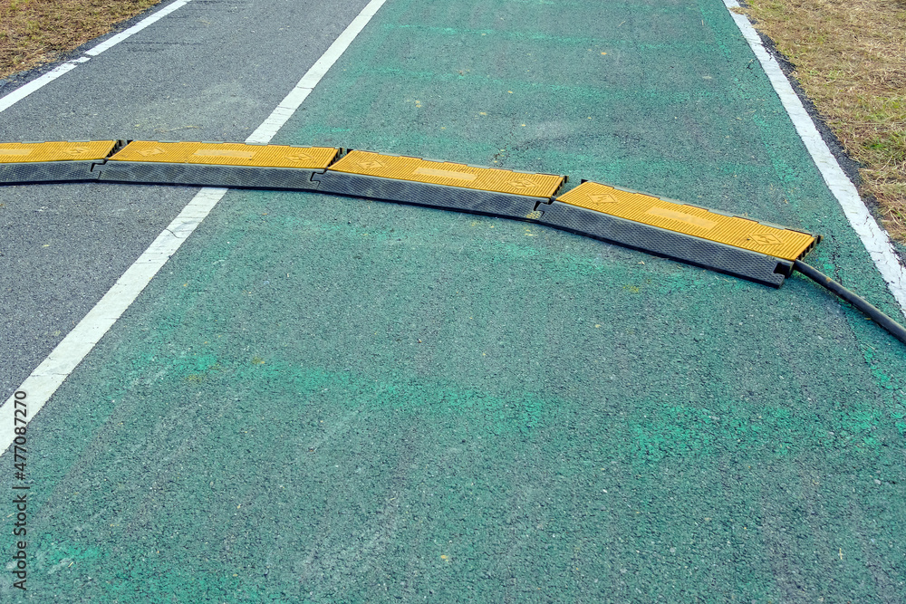 Black and yellow heavy plastic covers for people and vehicle to cross ...