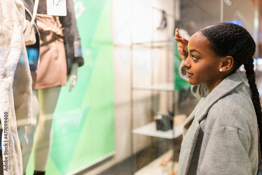 Girl doing window shopping at mall Stock Photo | Adobe Stock