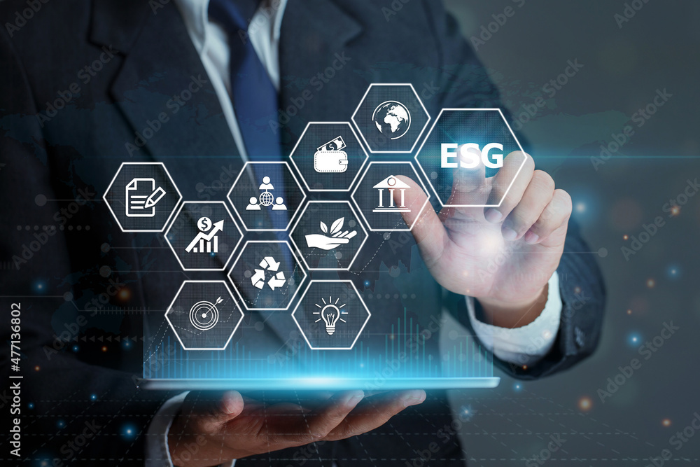 Businessman touching button ESG on-screen with connected virtual icons ...