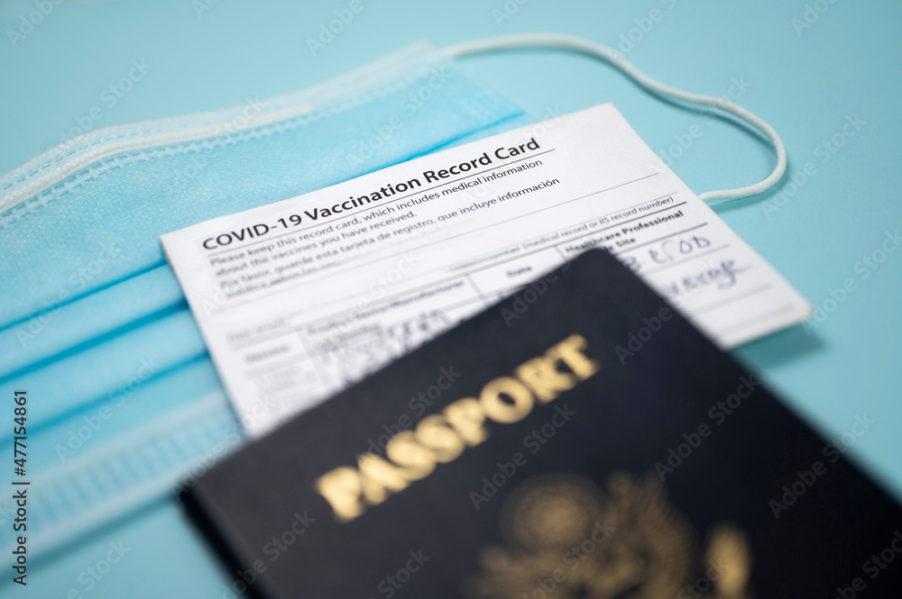 Covid-19 vaccination record card with passport and blue face mask Stock ...