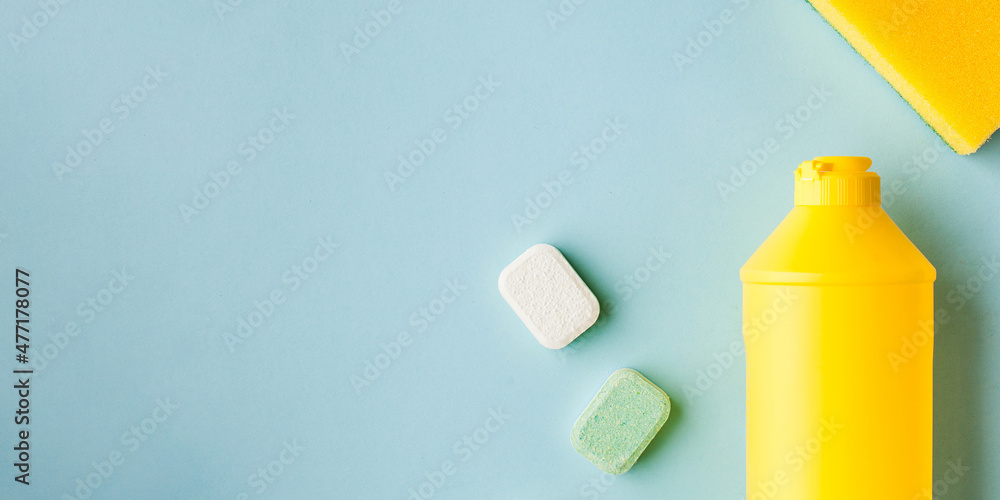 Liquid dishwashing liquid, dishwasher tablets on a blue background ...