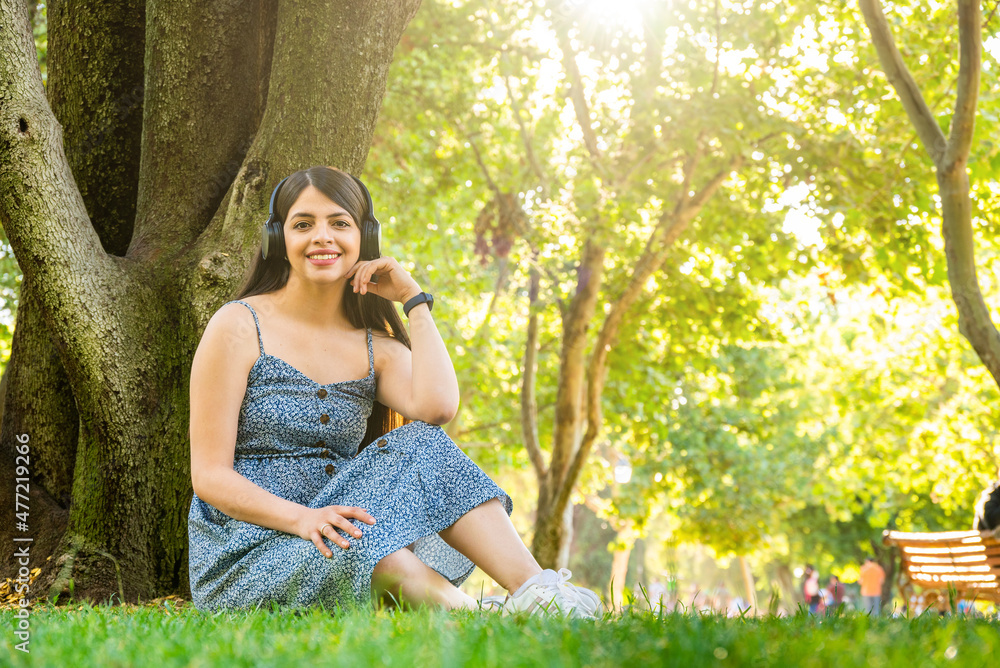 Young woman at park using a dress during summer spring season at a ...