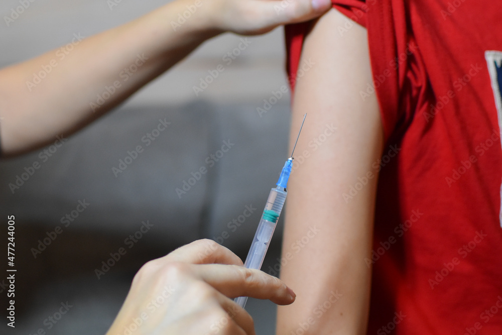 compulsory vaccination of children and adolescents. the doctor makes an ...