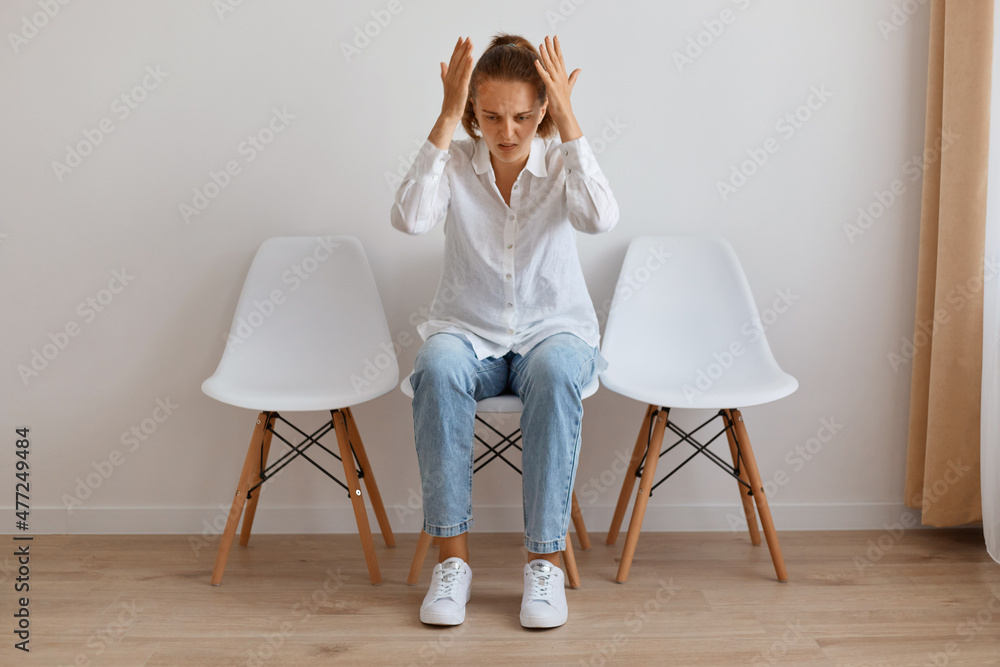 Horizontal shot of angry Caucasian young adult woman with ponytail ...