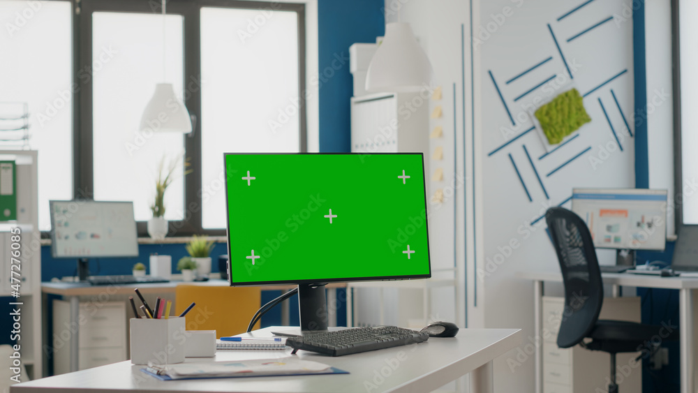 Close up of empty desk with isolated green screen on monitor. Computer ...
