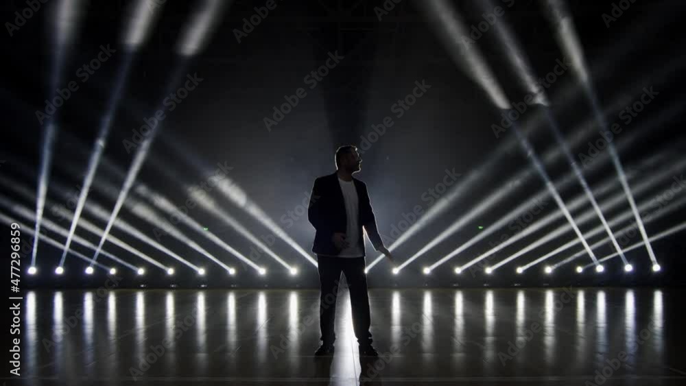 Famous Showman, artist in black suit performs on stage 4K. The ...