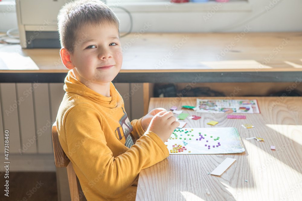 Little boy being creative making homemade do it yourself dinosaur ...