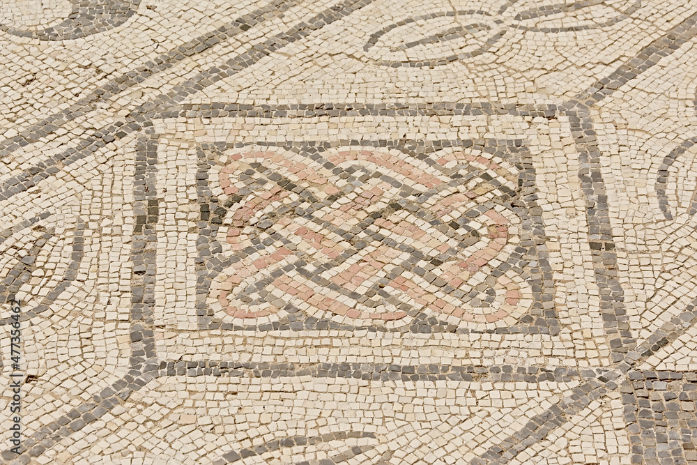 Ornate ancient roman floor mosaic wih geometrical patterns in ...