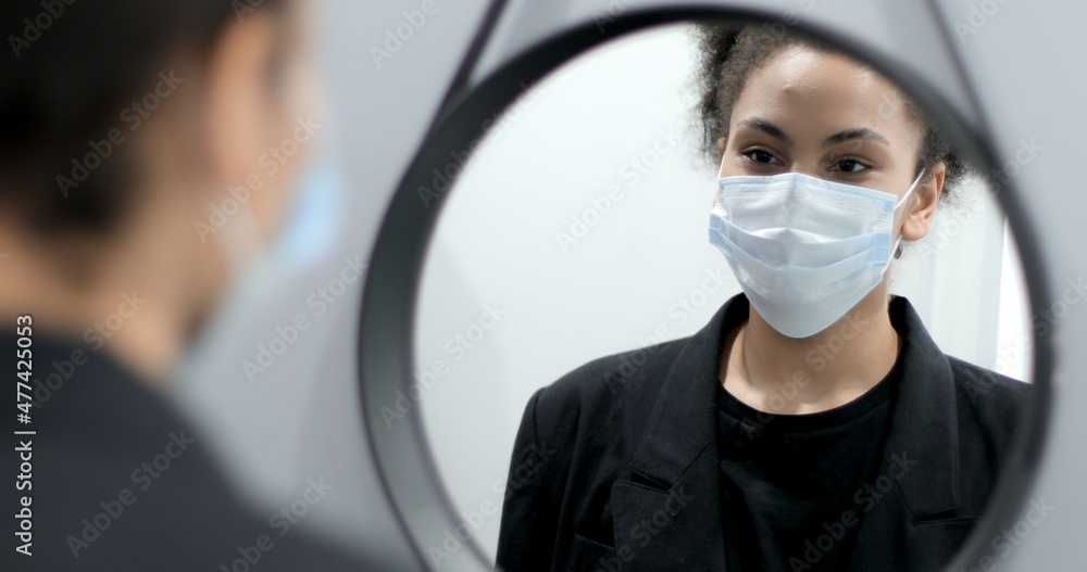 Black woman putting on face mask against virus bacteria prevention ...