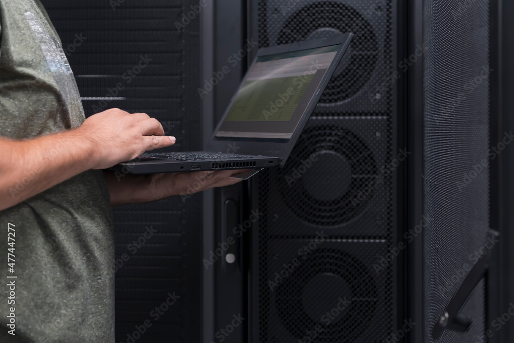 Data Center Engineer Using Laptop Computer. Server Room Specialist ...