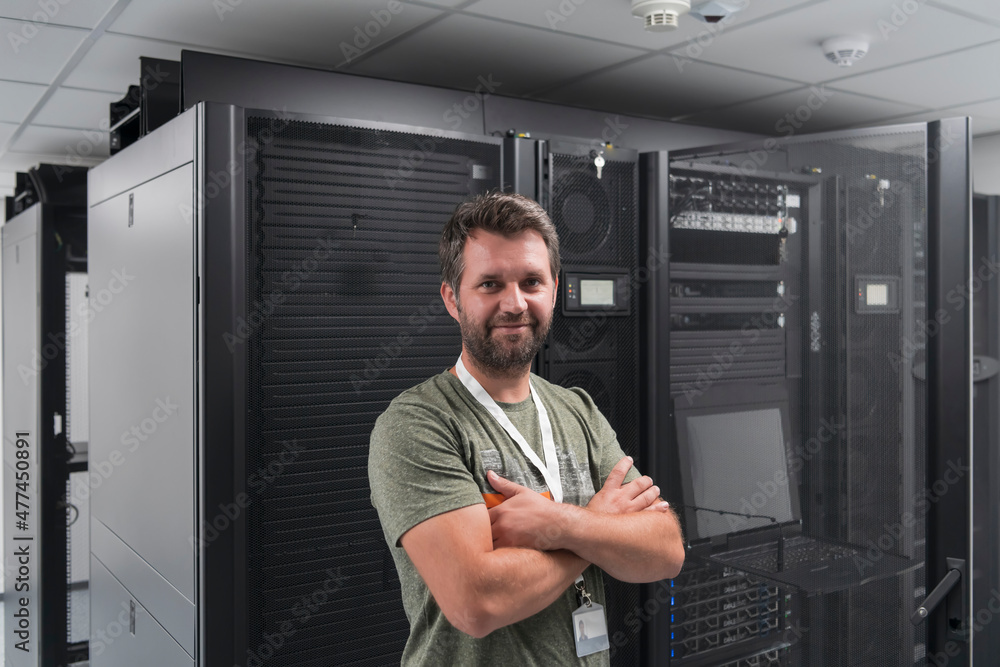 Portrait of male technician or network administrator standing brave as ...