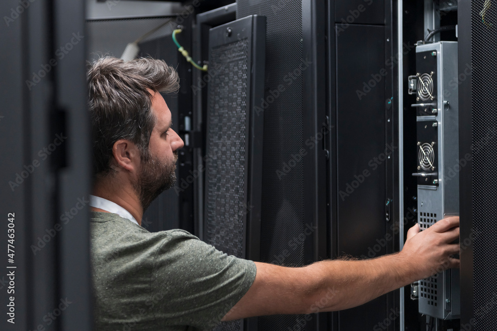 IT engineer working In the server room or data center The technician ...