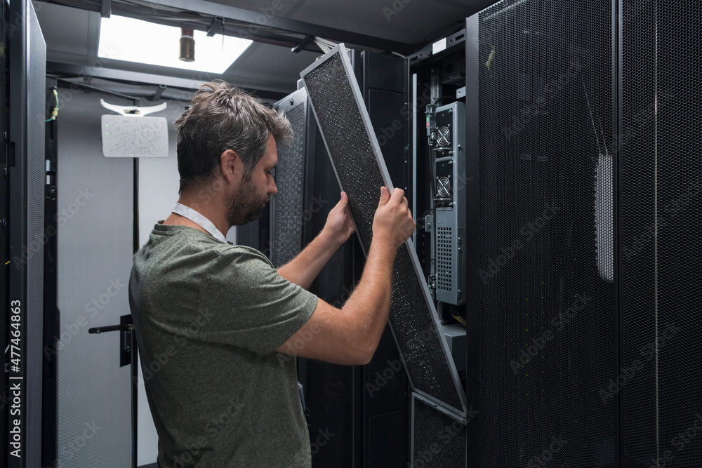 IT engineer working In the server room or data center The technician ...