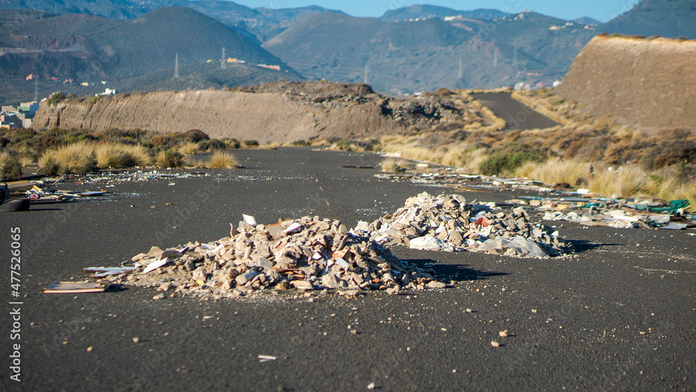 rubble and garbage thrown and abandoned on the street in a vacant lot ...