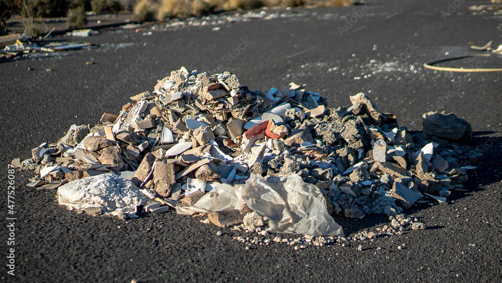 rubble and garbage thrown and abandoned on the street in a vacant lot ...