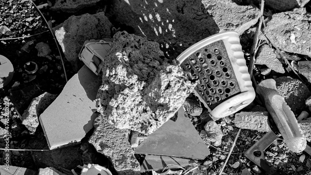rubble and garbage thrown and abandoned on the street in a vacant lot ...