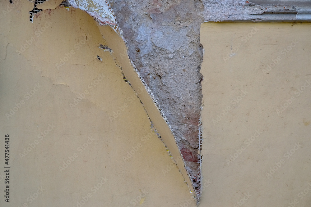 Exterior wall of a building with damaged stucco. Demonstration of poor ...