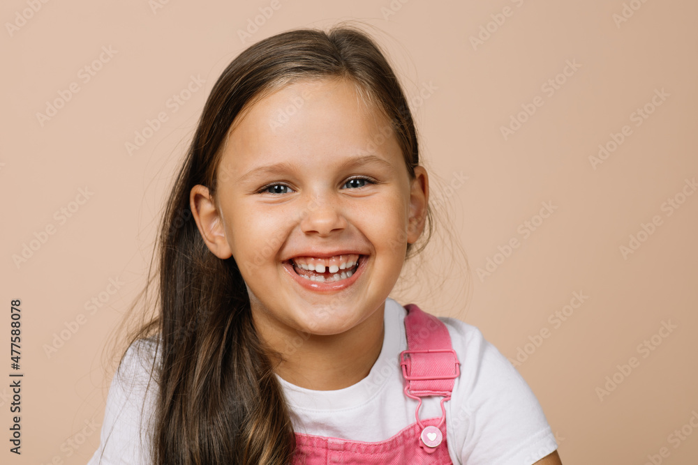 Close-up face kid with bright shining eyes and excited happy smile with ...
