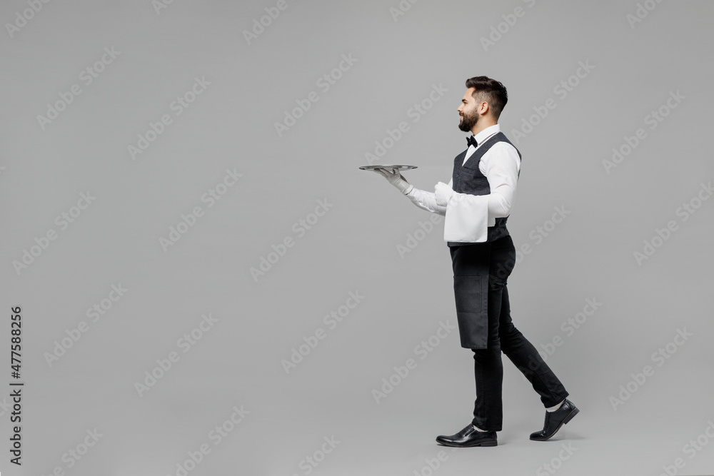 Full body side view young barista male waiter butler man in white shirt ...