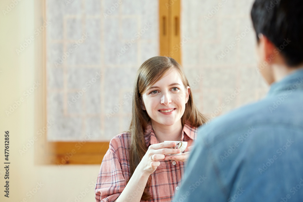 A foreigner and a Korean couple having a tea ceremony in a traditional ...