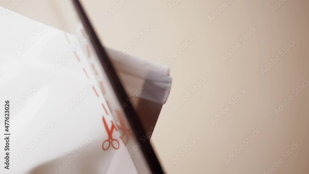 Open here concept. Scissors open package with liquid soap cutting off ...