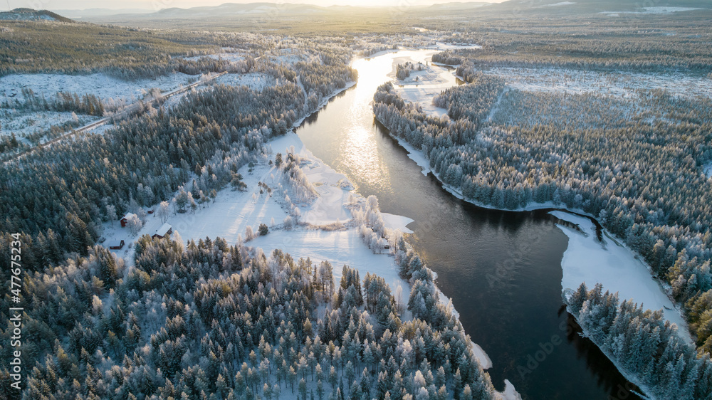 Aerial view of snowy winter forest with black river. Drone photography ...