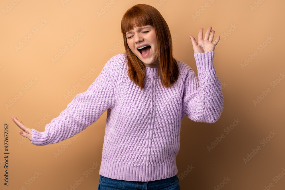 Victorious delighted happy ginger woman raising hands, shouting for joy ...