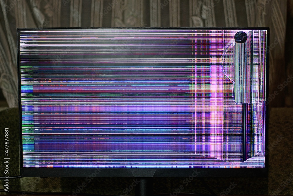 one rectangular monitor with a cracked screen and colored stripes ...