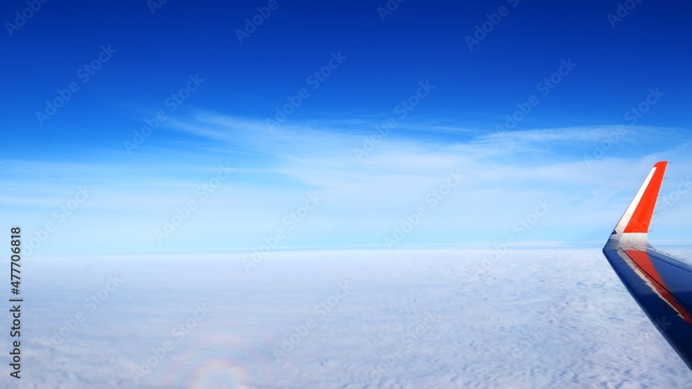 endless clouds under the plane and the blue, bottomless blue sky, the ...