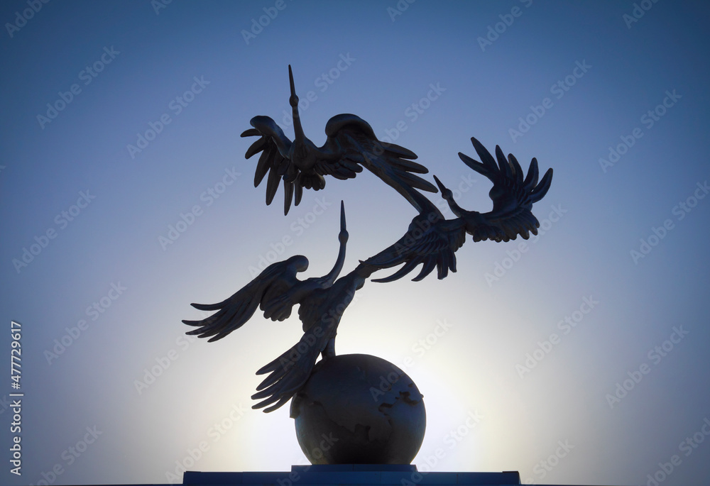 Sculpture of three storks over the globe on Ezgulik Arch as a symbol of ...