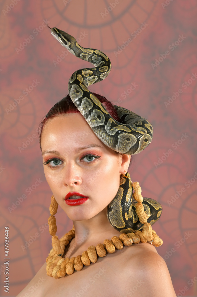 A beautiful woman poses nude for the camera. She is seen wearing a ...