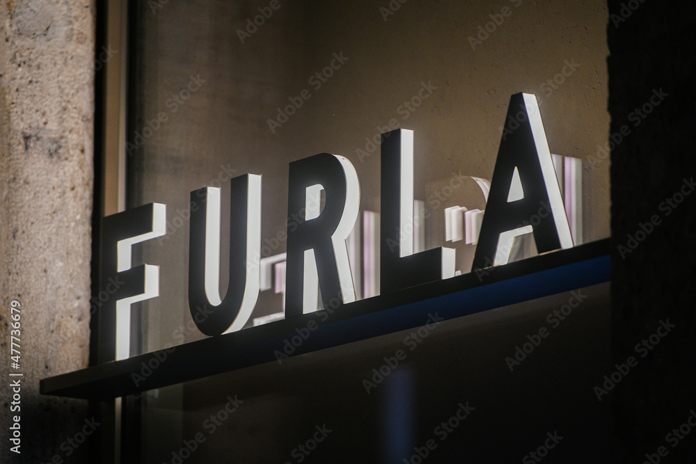 Furla logo displayed on a facade of a store in Milan. Stock Photo ...