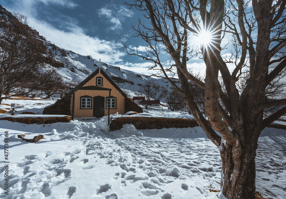 Hofskirkja Church, Hof, Iceland in winter with snow and blue sky. This ...